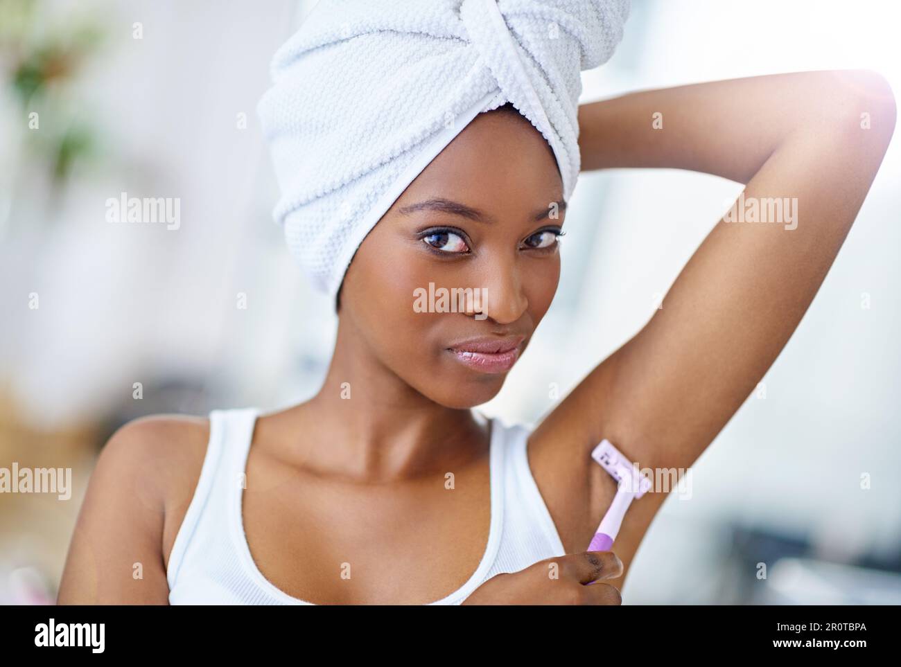 My razor keeps me ever-ready. a beautiful young woman during her daily ...