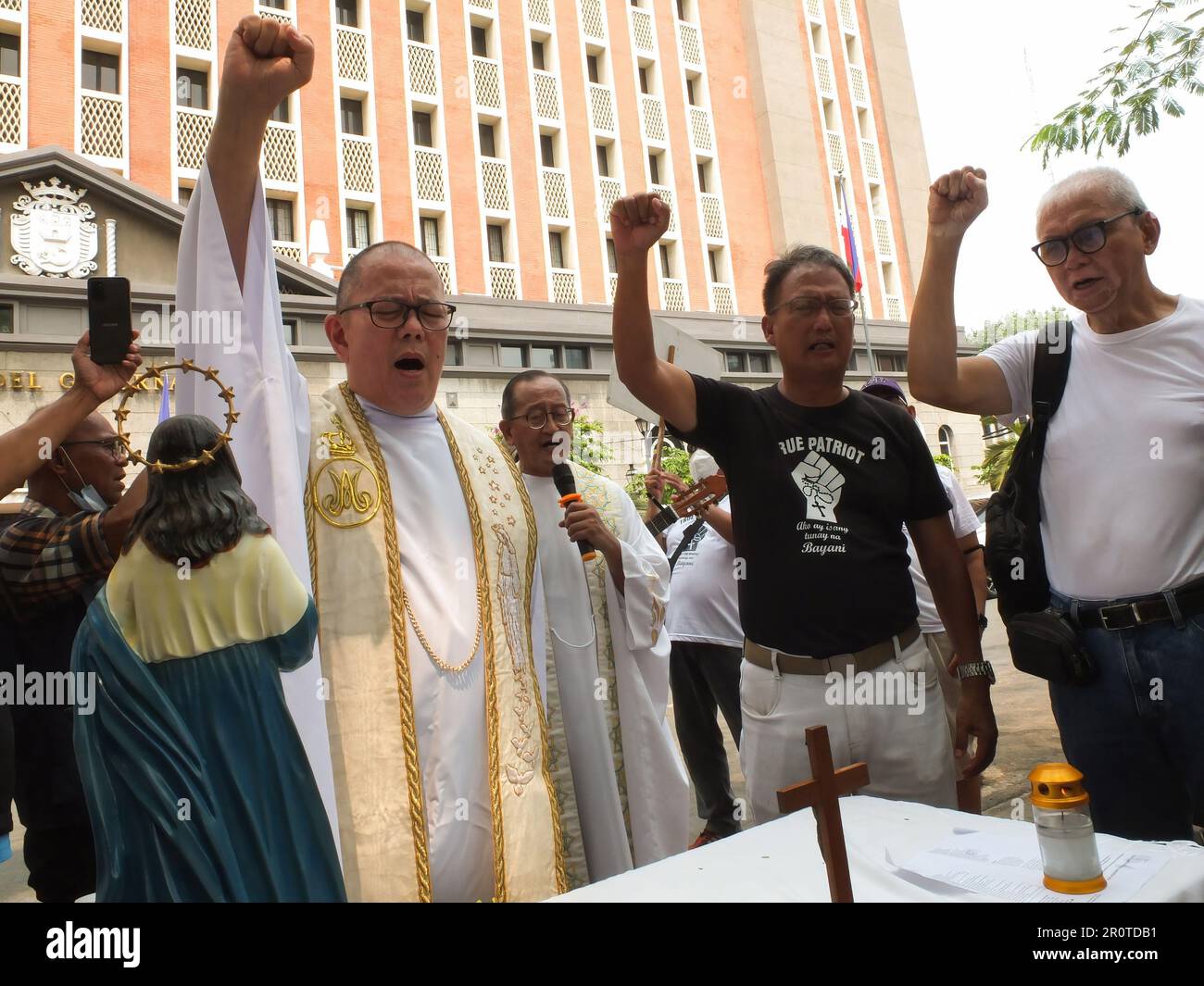 Father, Robert Reyes with other progressive group raise their fists ...