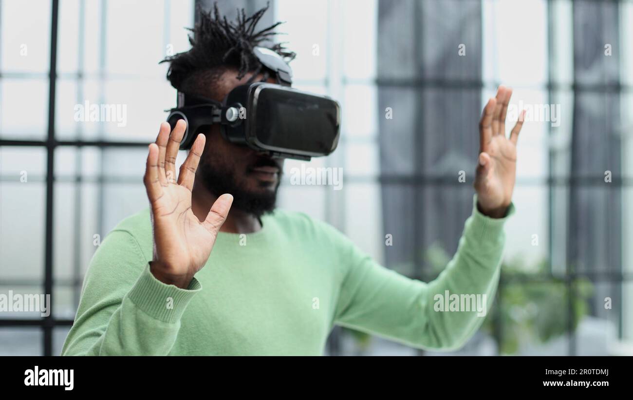 Cool handsome african american man put on virtual reality goggles for ...