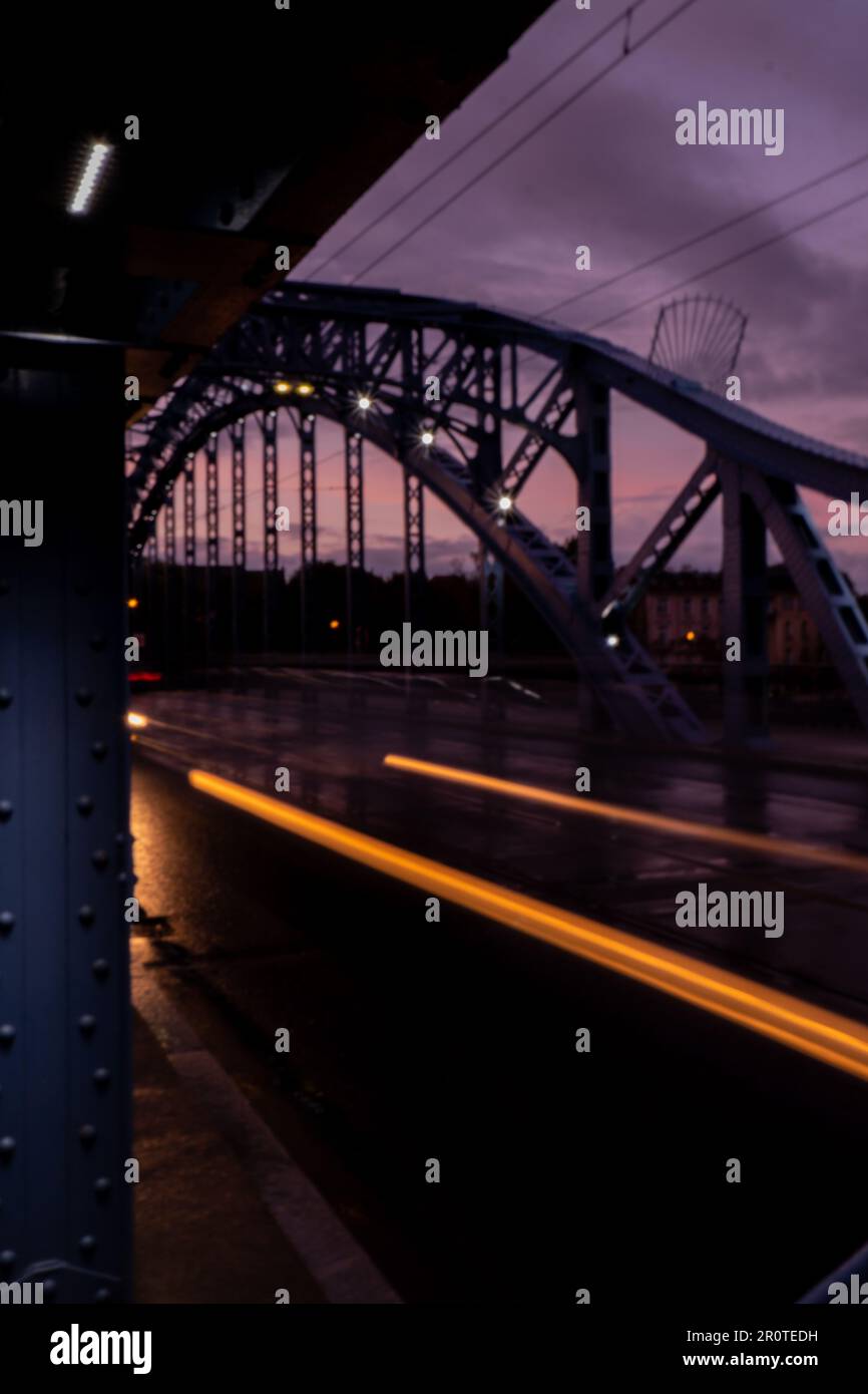 Defocused Lights of cars at night in Krakow bridge. Street line lights ...