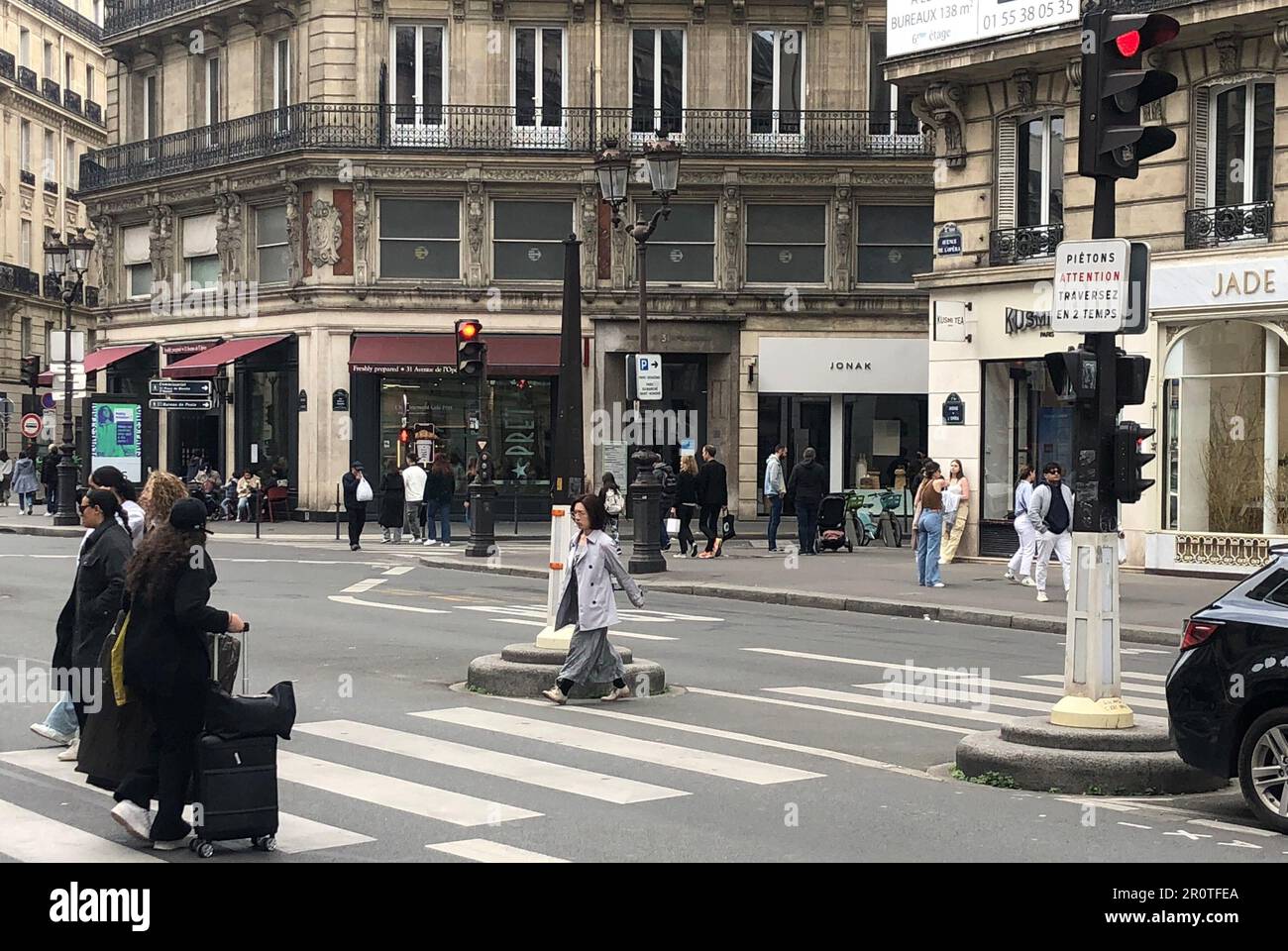 Paris, France. 30th Apr, 2023. Pedestrians crossing a two-way crosswalk ...