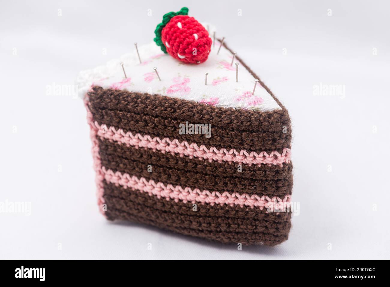 Chocolate and raspberry cake pincushion with a strawberry on top Stock ...