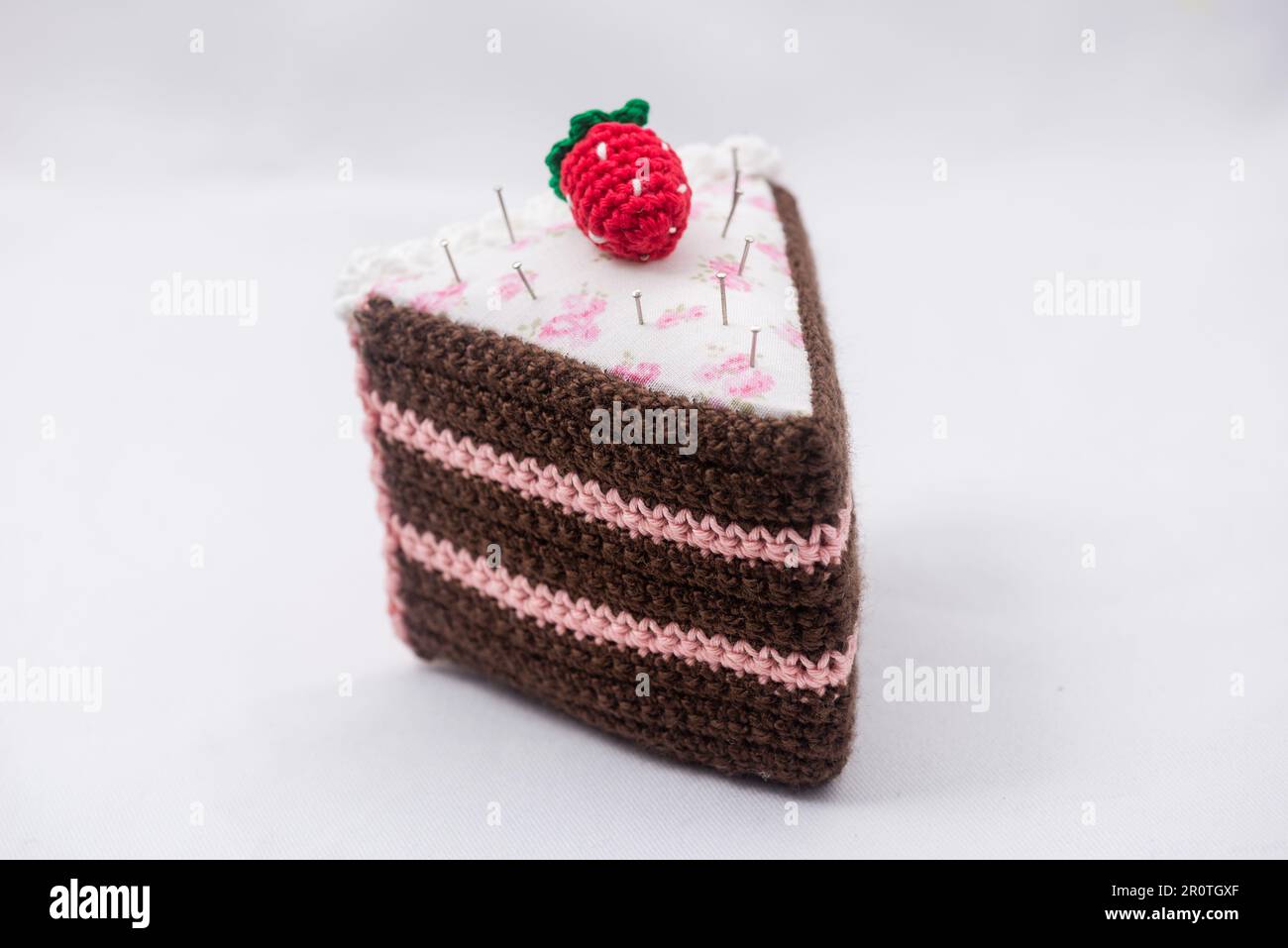 Chocolate and raspberry cake pincushion with a strawberry on top Stock ...