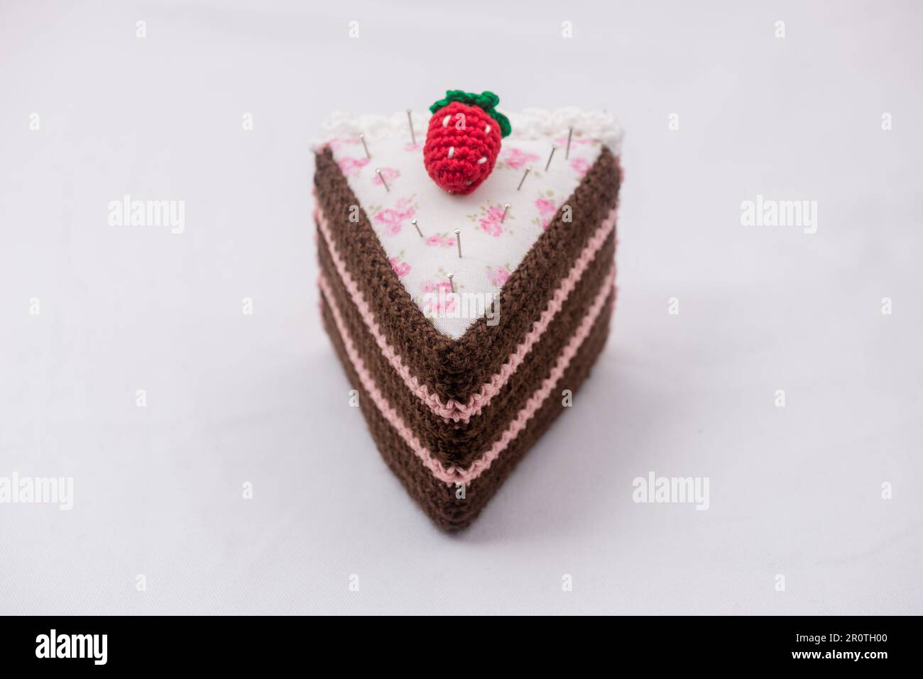 Chocolate and raspberry cake pincushion with a strawberry on top Stock ...