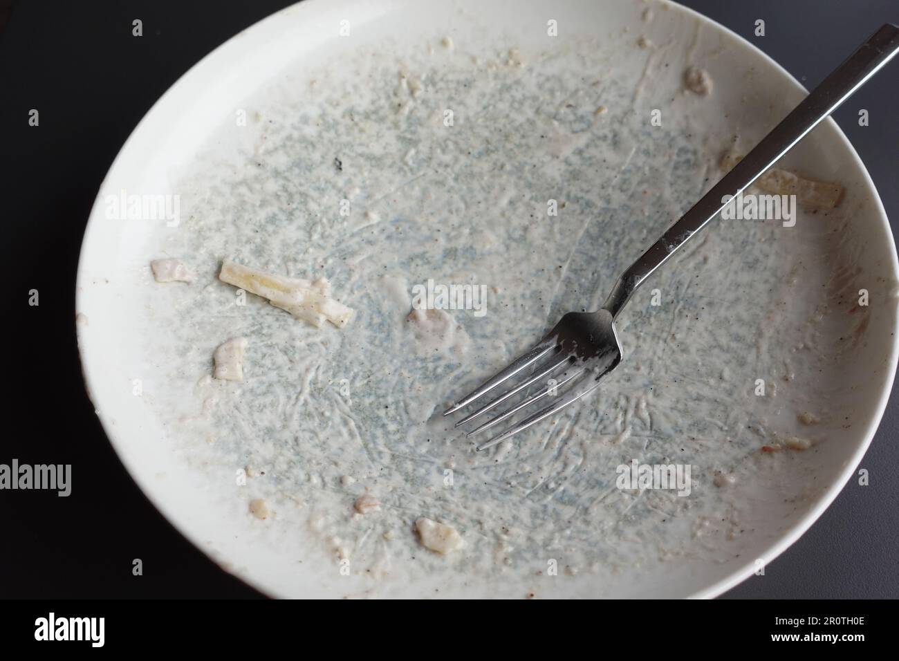 Empty plate after eating on table Stock Photo - Alamy