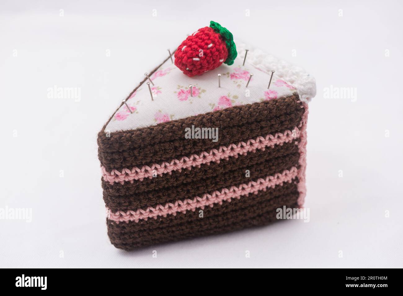 Chocolate and raspberry cake pincushion with a strawberry on top Stock ...