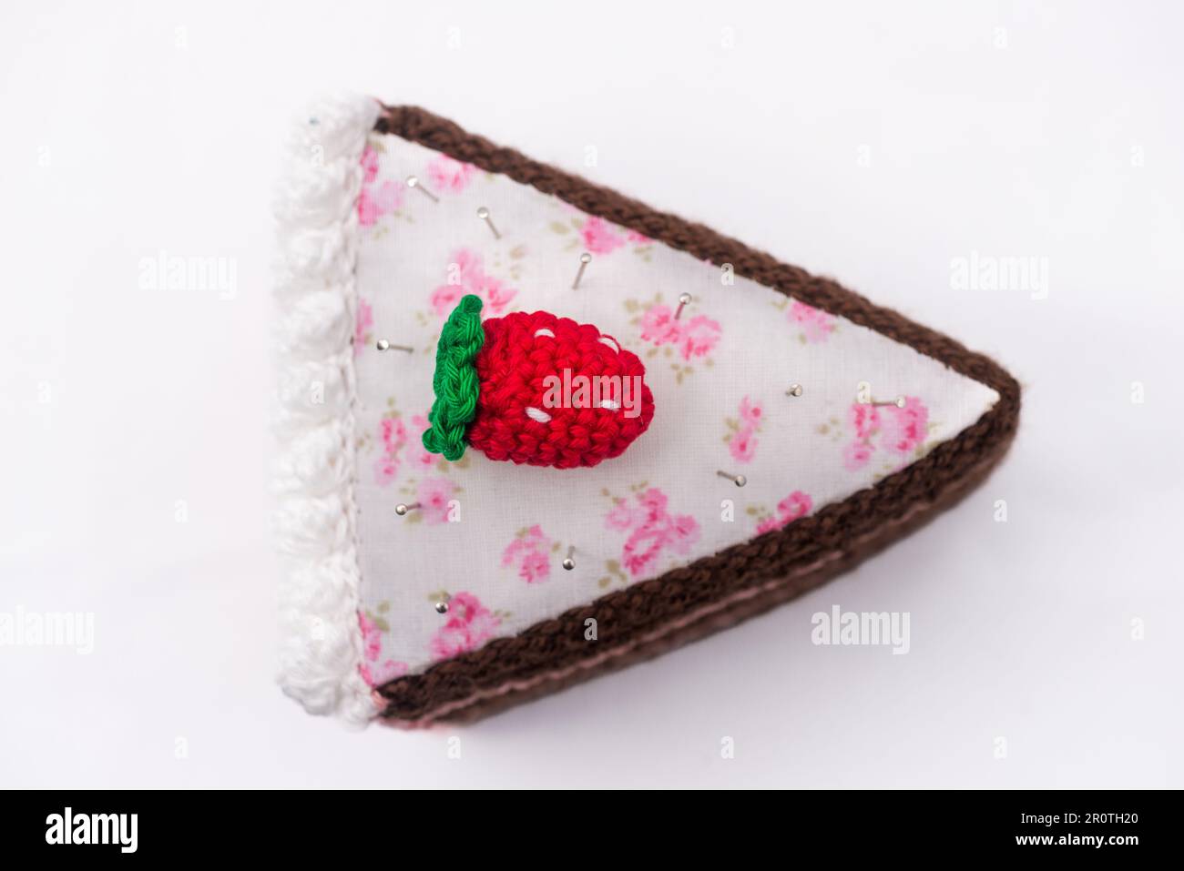 Chocolate and raspberry cake pincushion with a strawberry on top Stock ...