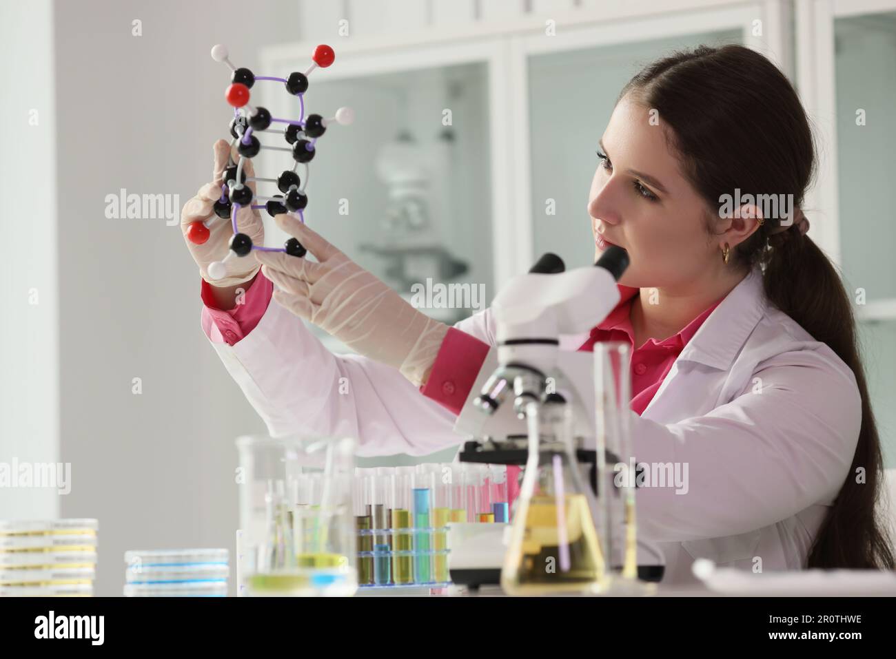 Female scientist looking at molecule model hi-res stock photography and ...