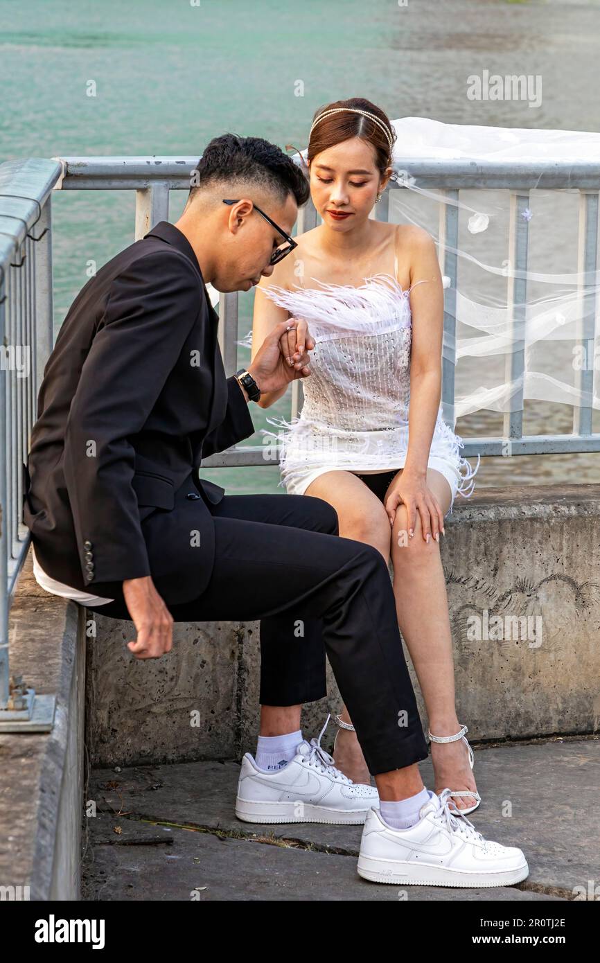 Vietnamese wedding couple holding hands, posing for photographs in ...