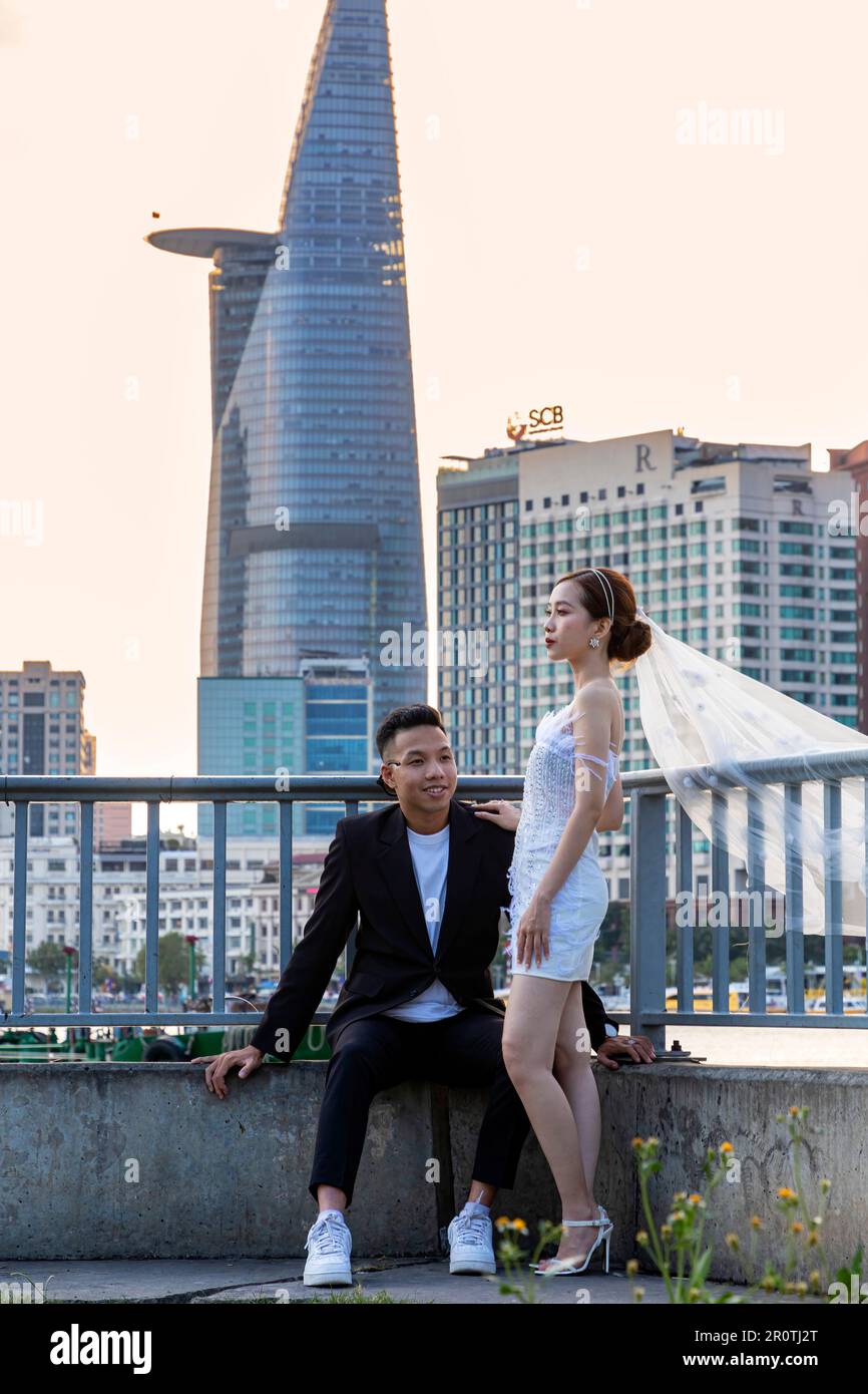 Vietnamese wedding couple posing for photographs in front of Ho Chi ...
