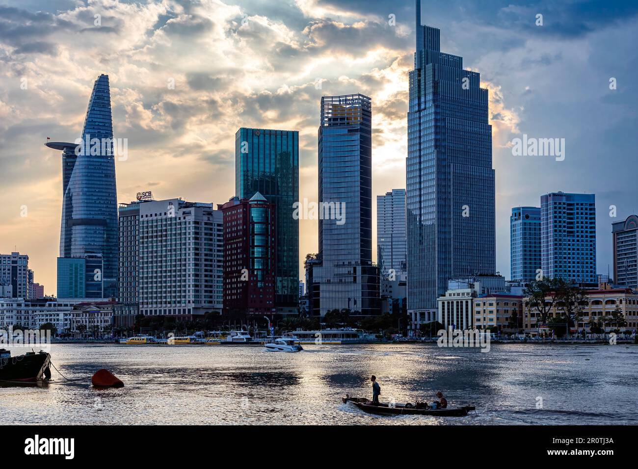 Boats on Saigon river in front of skyscrapers and building skyline, Ho ...