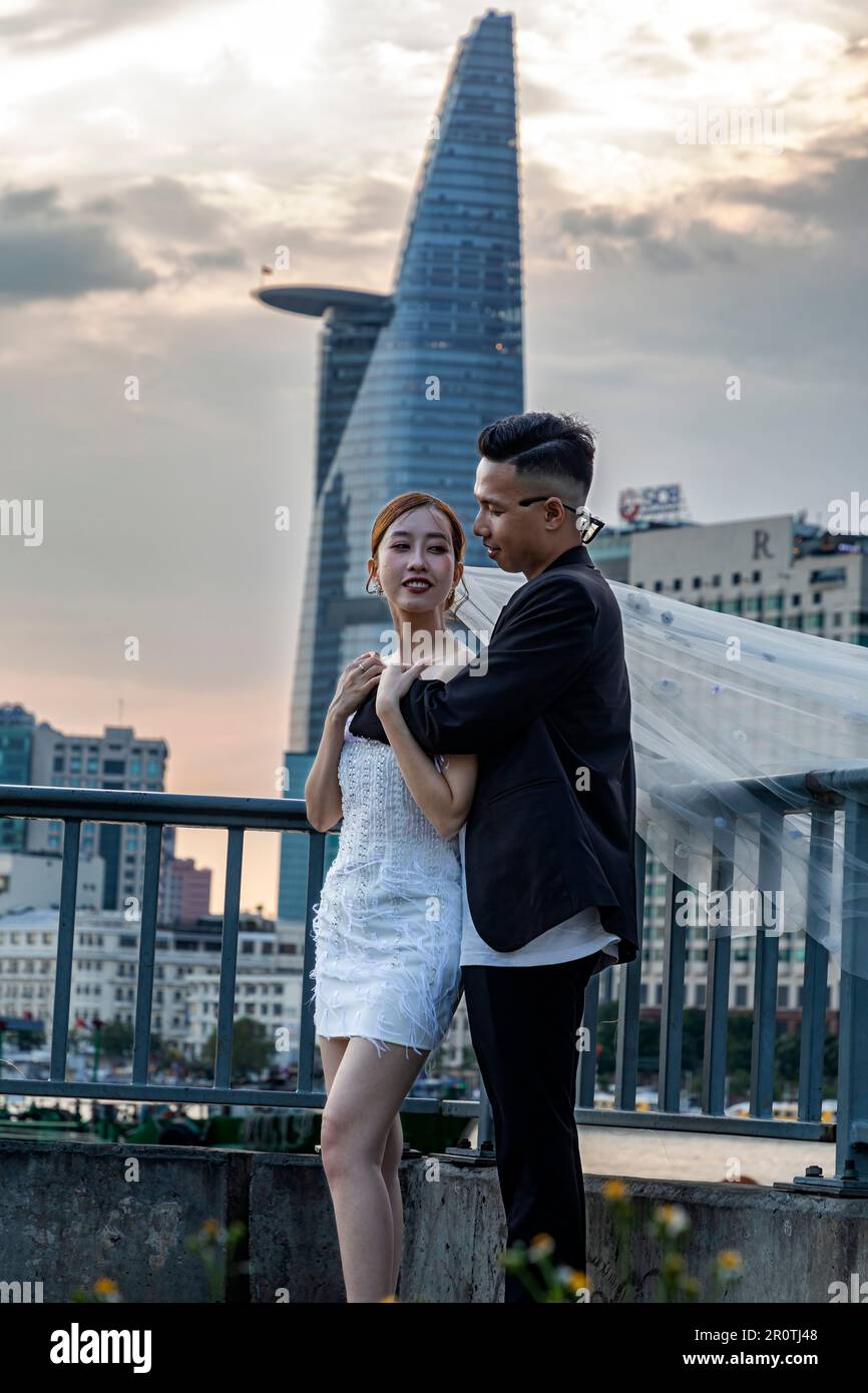 Vietnamese wedding couple posing for photographs in front of Ho Chi ...