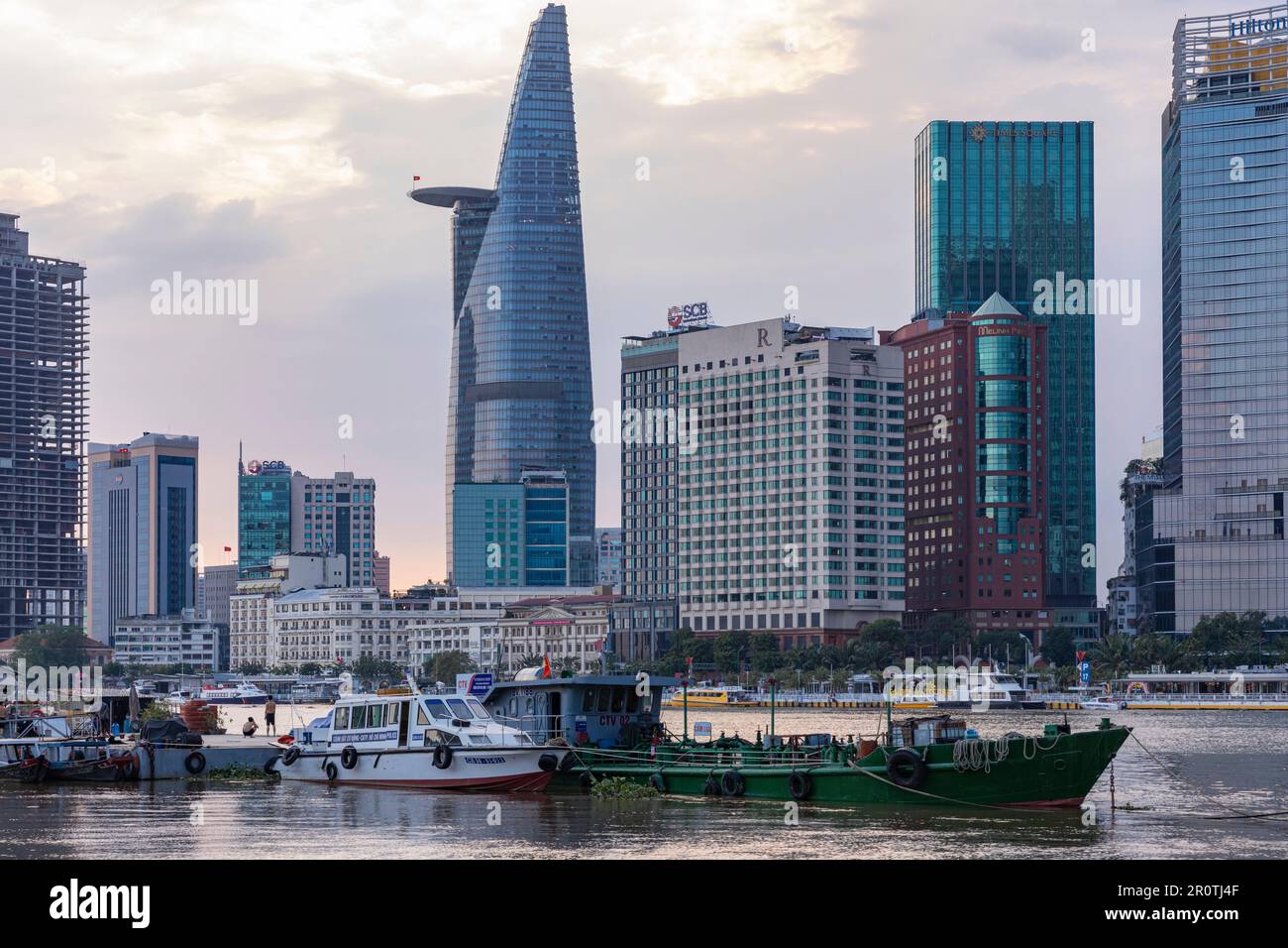 Boats on Saigon river in front of skyscrapers and building skyline, Ho ...