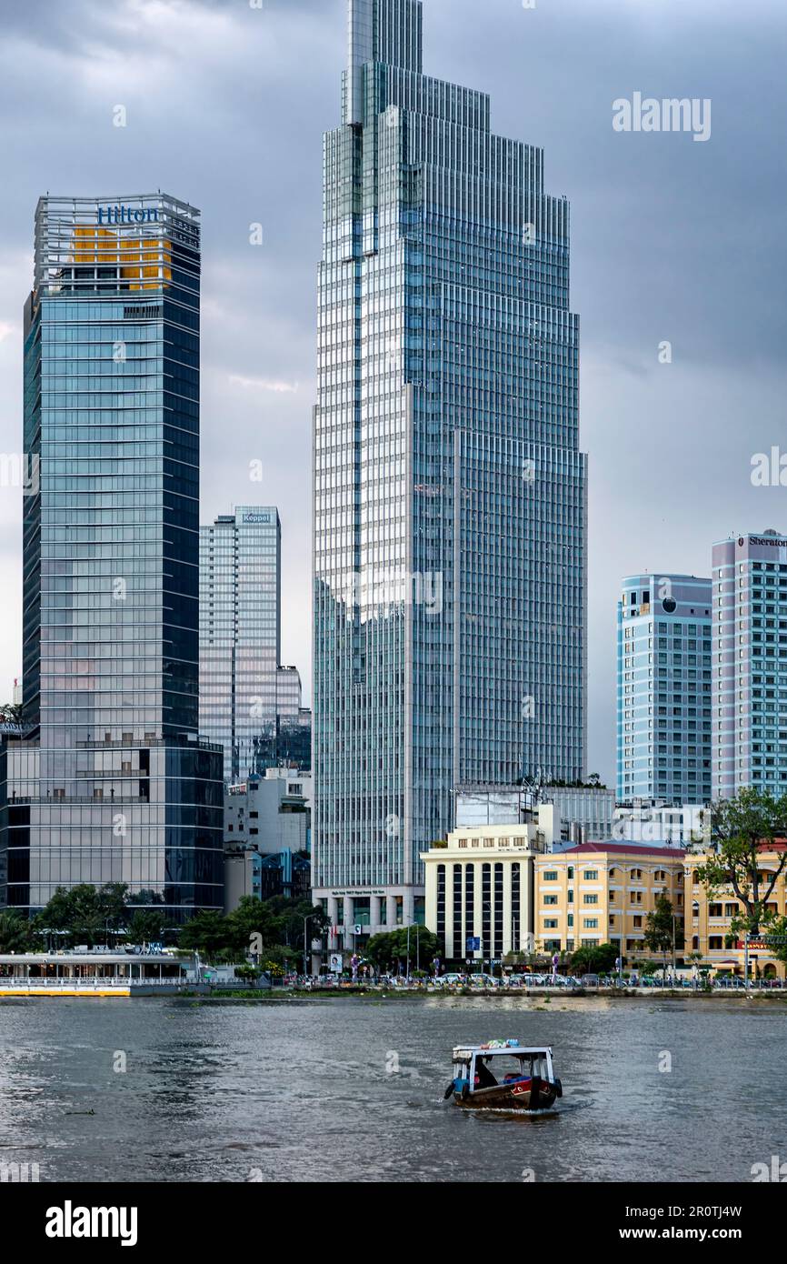 Boats on Saigon river in front of skyscrapers and building skyline, Ho ...