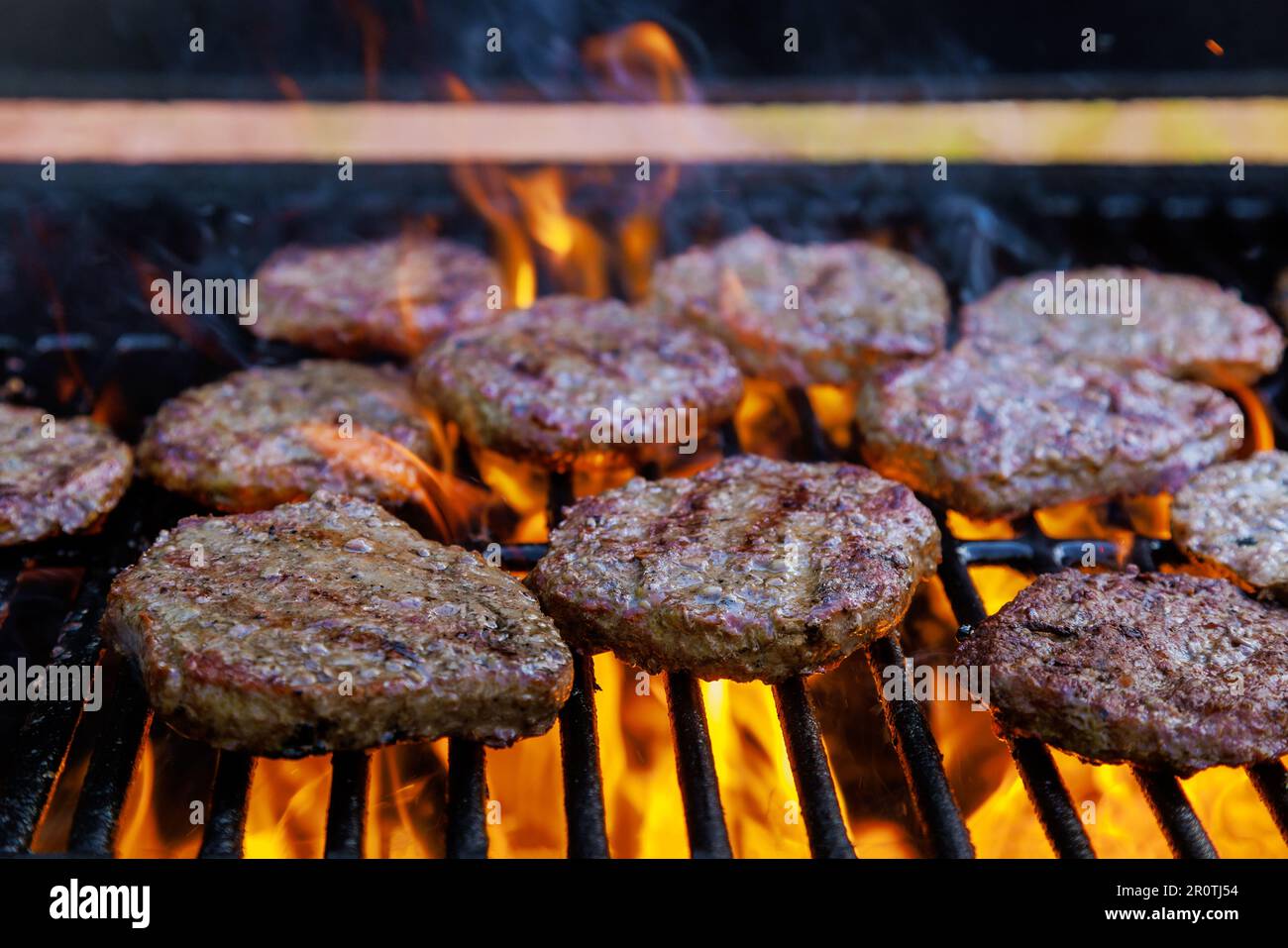 Grilled American beef burger is barbecued an hot grill on flame Stock ...