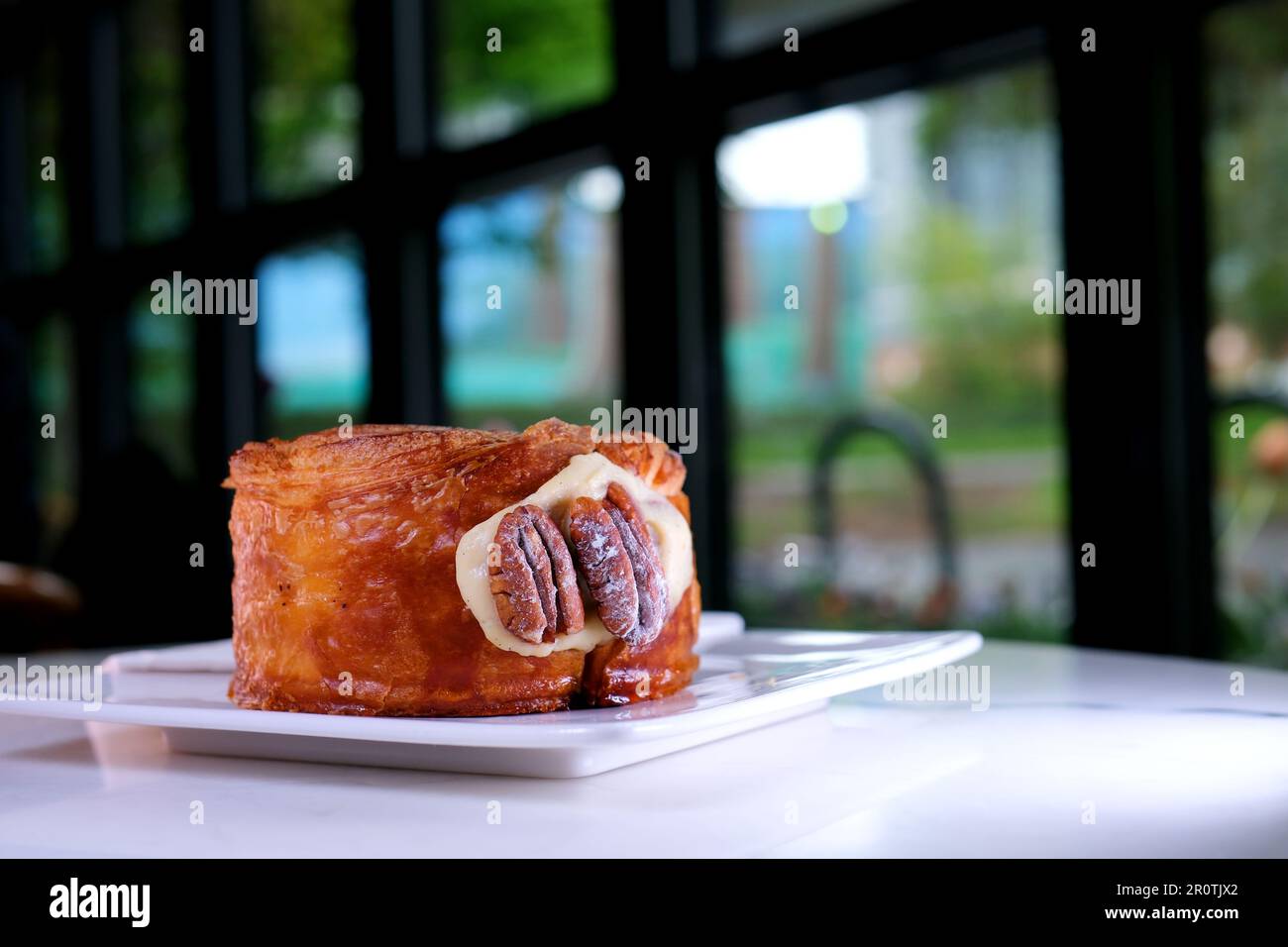 delicious dessert in a restaurant on a white plate round croissant with ...