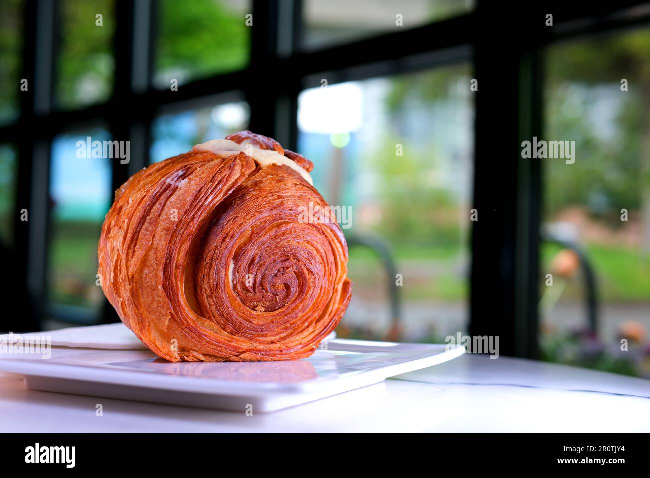delicious dessert in a restaurant on a white plate round croissant with ...