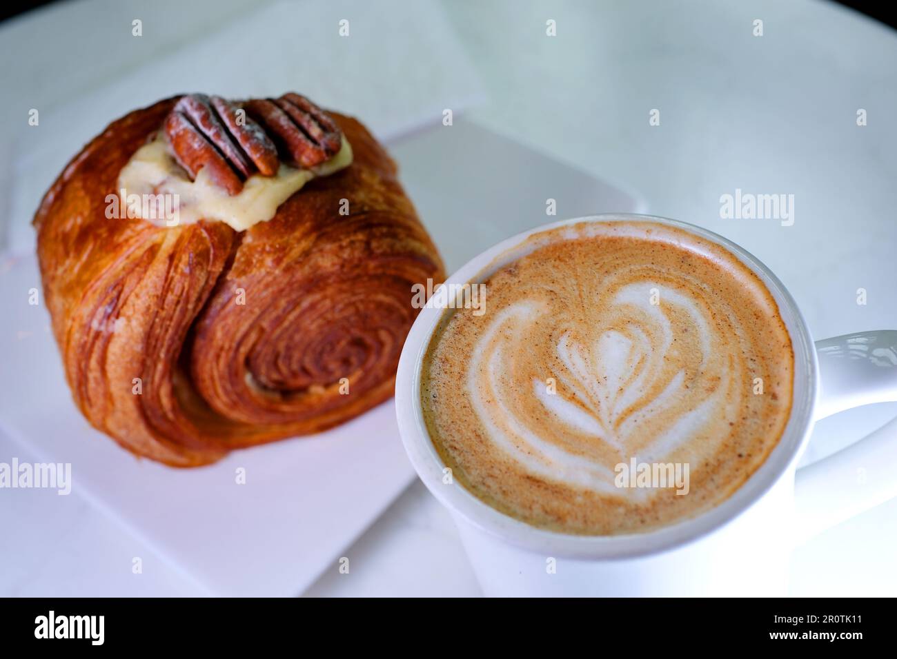delicious dessert in a restaurant on a white plate round croissant with ...