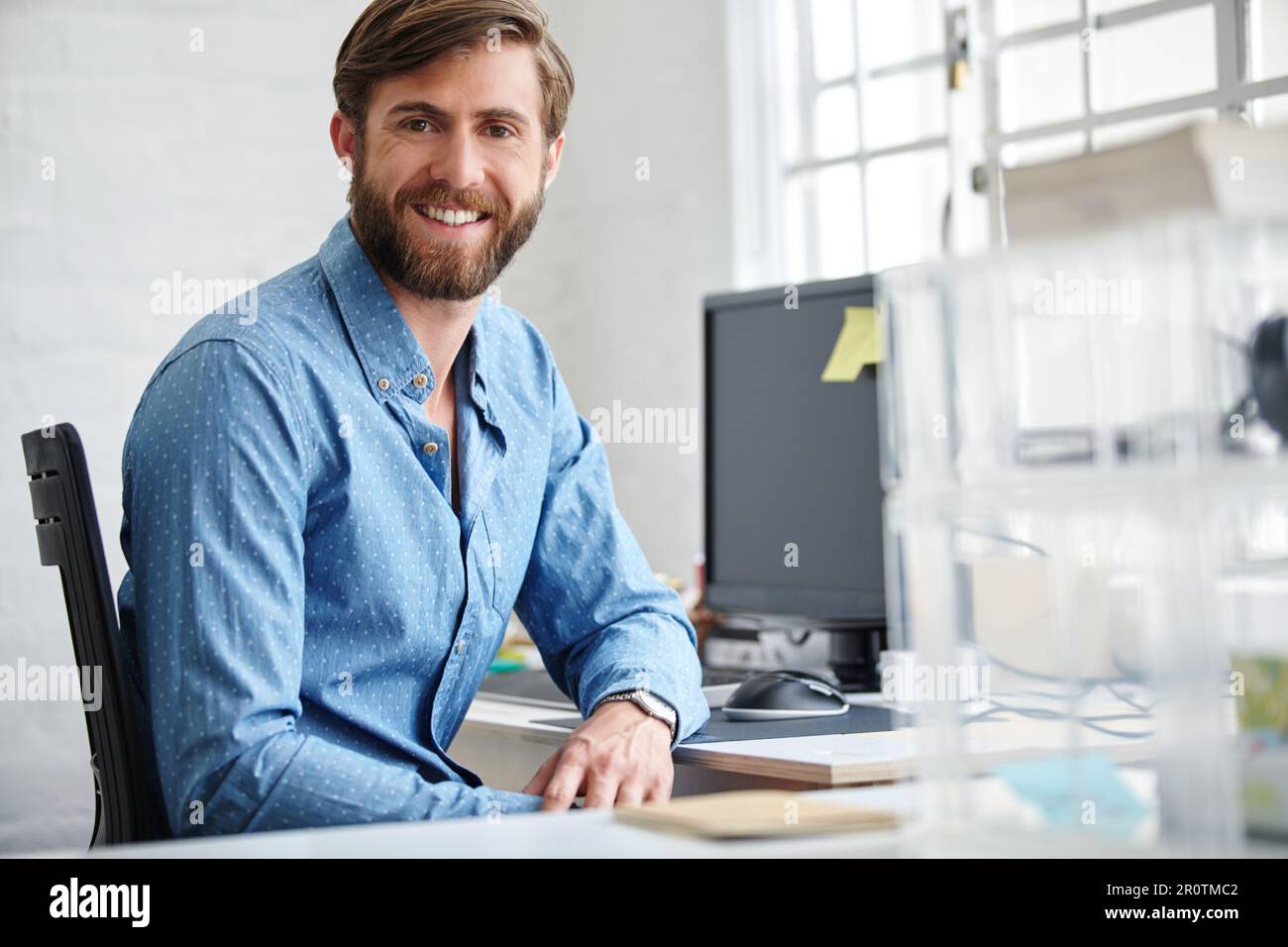 Dont stop until youre proud. a handsome designer smiling at the camera ...