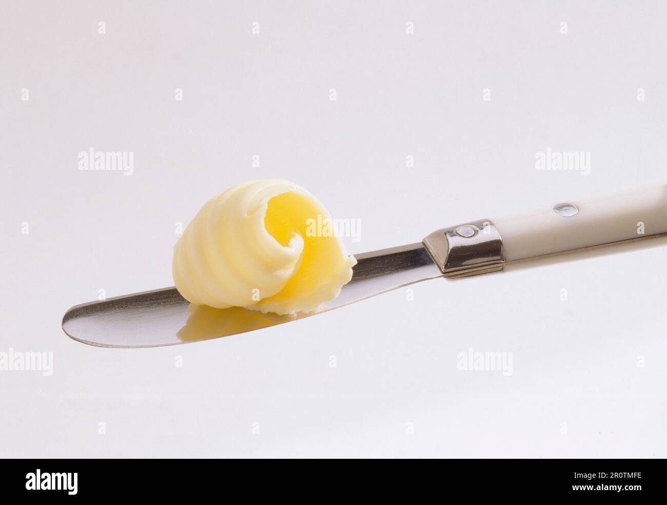 Curl of butter on knife Stock Photo - Alamy