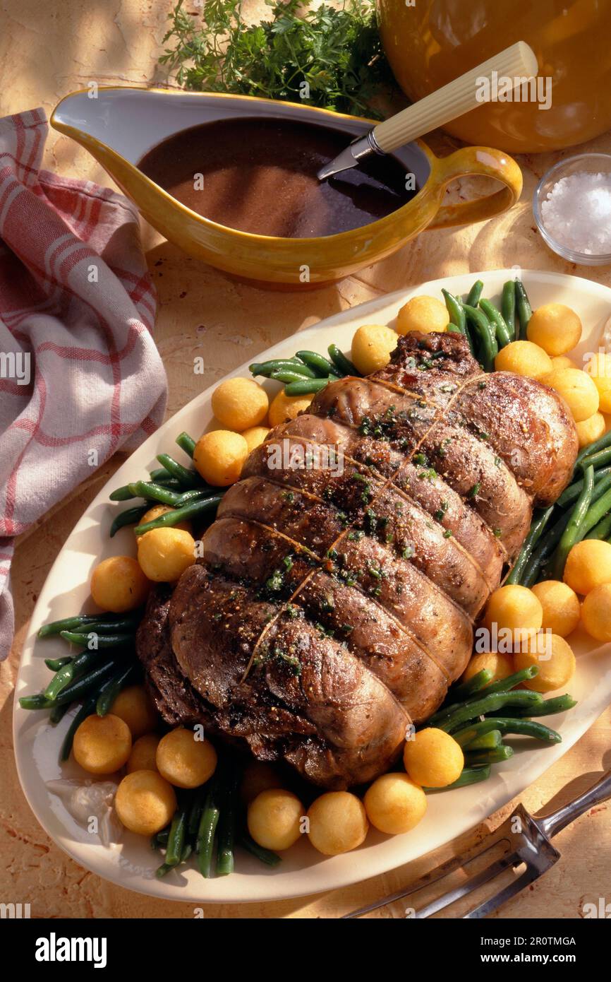 Roast haunch of venison without bone and pepper sauce Stock Photo - Alamy