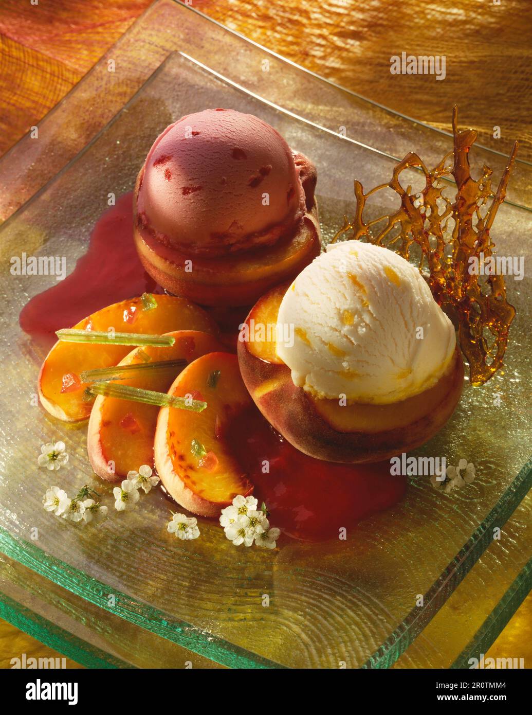 Roast peaches with peach and strawberry ice cream Stock Photo - Alamy