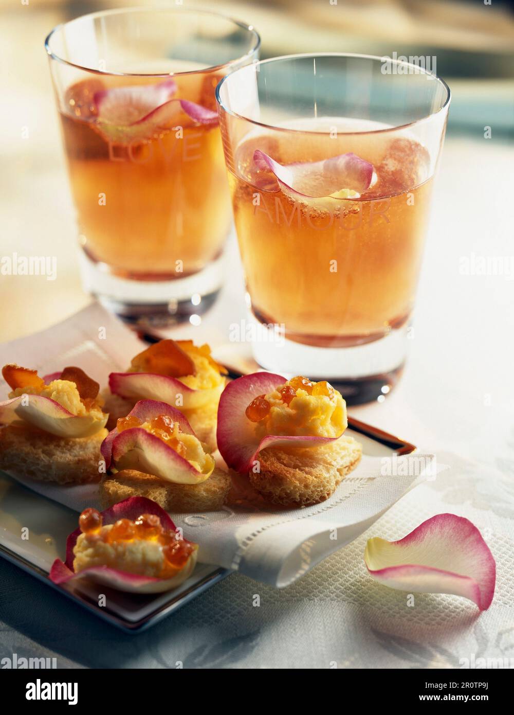 Champagne cocktail with liqueur and roses Stock Photo - Alamy