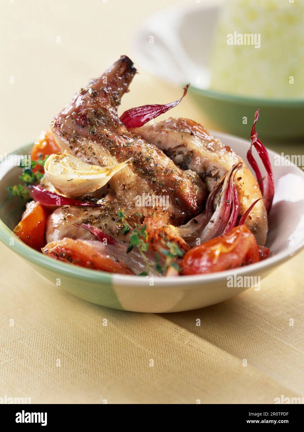 Roast rabbit with tomatoes and confit onions Stock Photo - Alamy