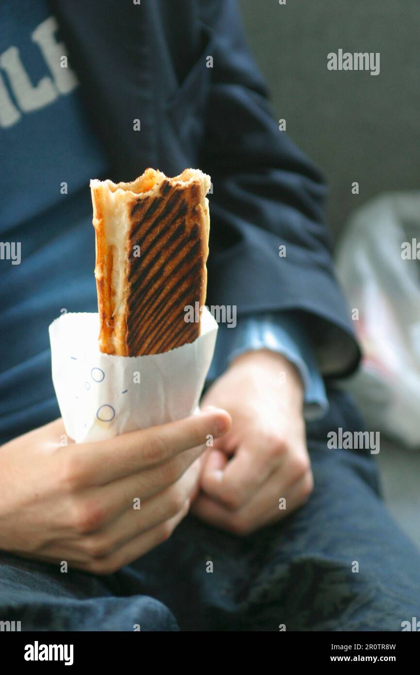 Eating a panini Stock Photo - Alamy