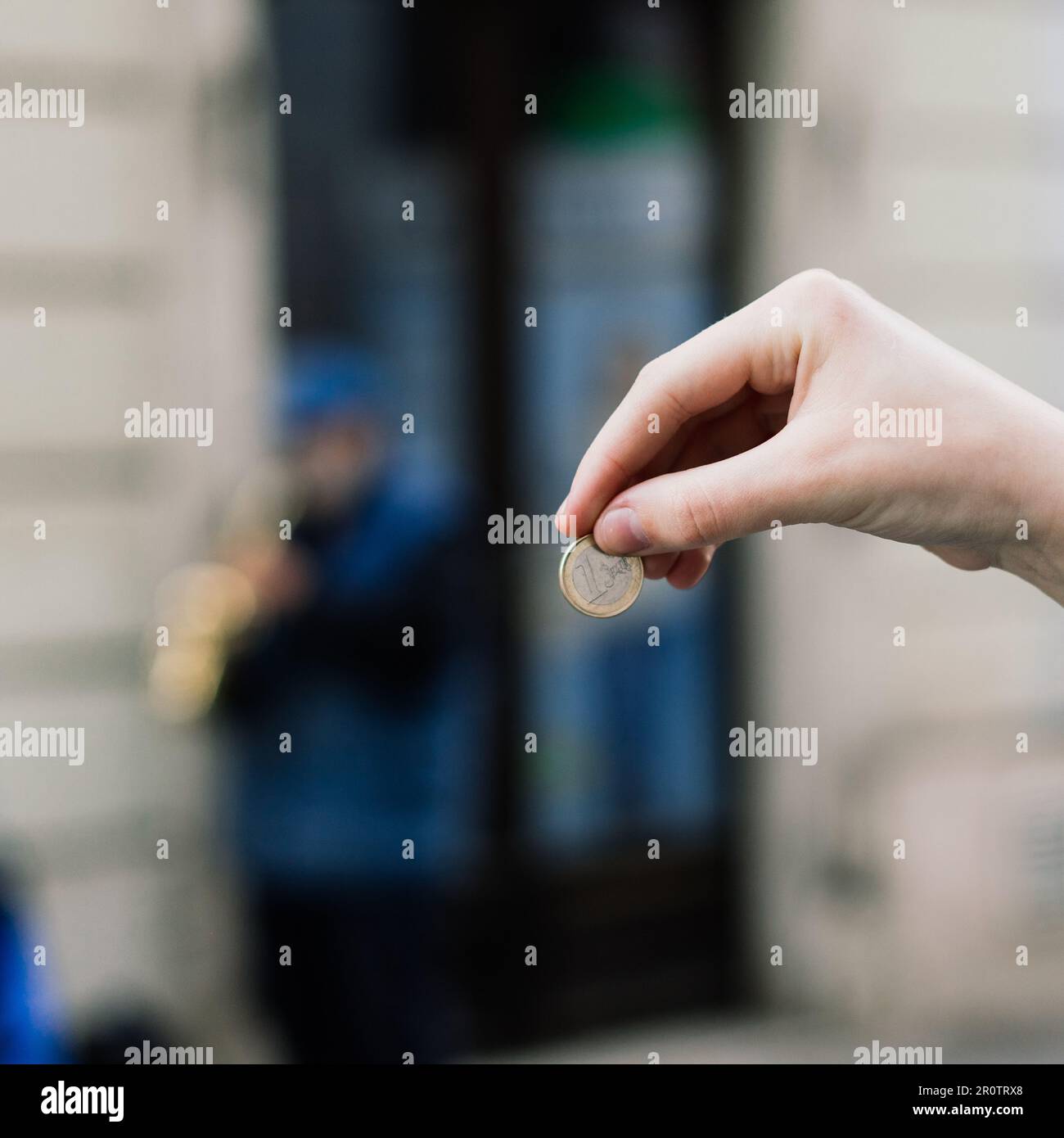 Street old performer musician plays saxofon blurred, coin in a hand ...