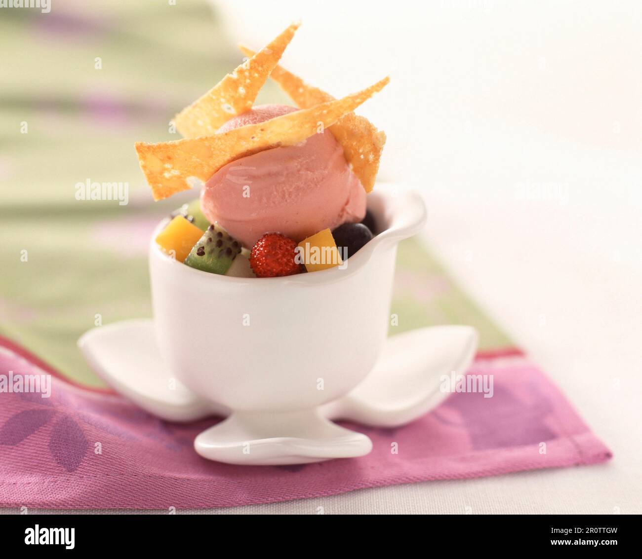 fruit salad, strawberry ice cream and pine nut triangle Stock Photo - Alamy