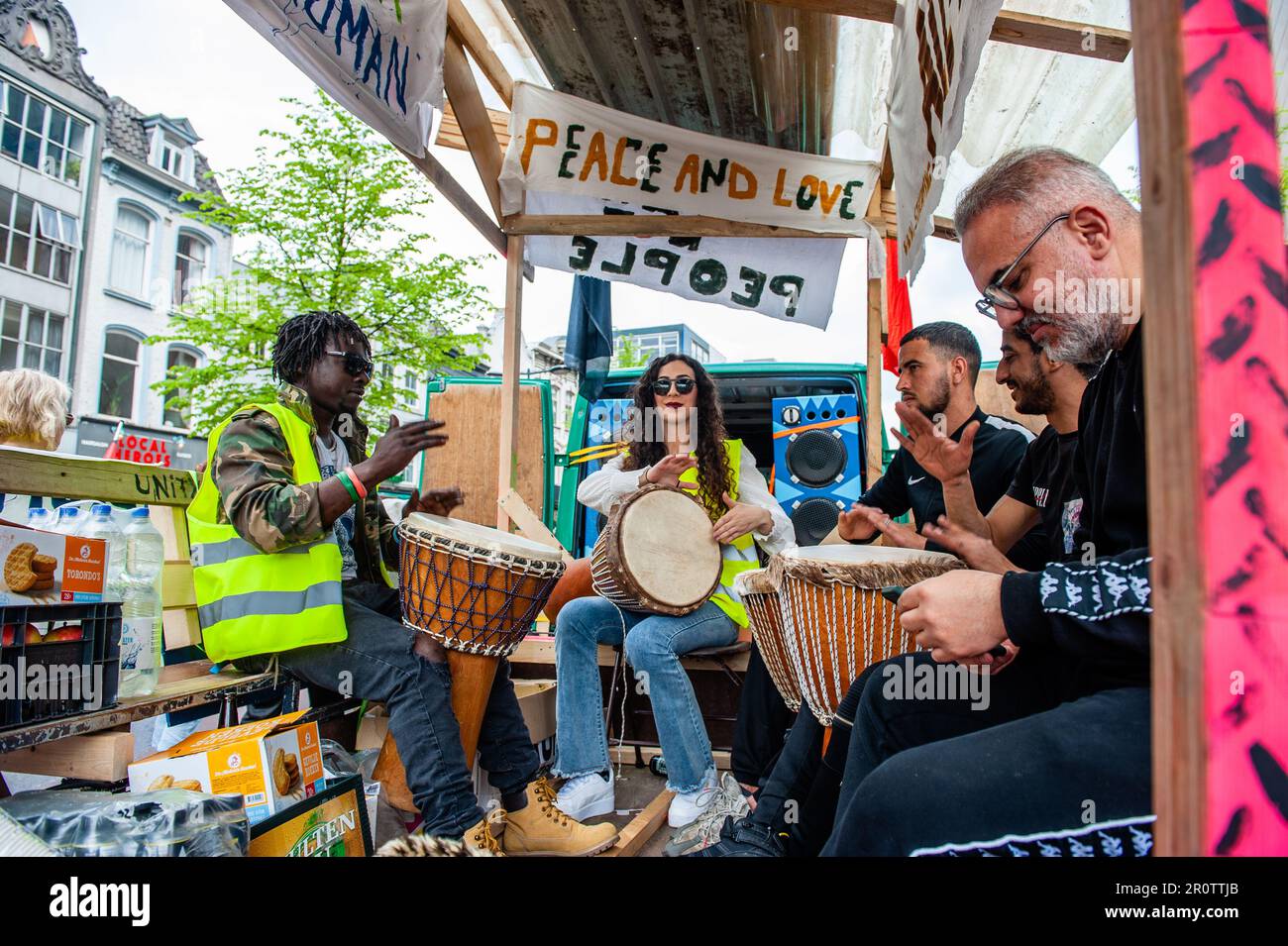 Protesters in support of refugees are seen playing the drums inside one ...