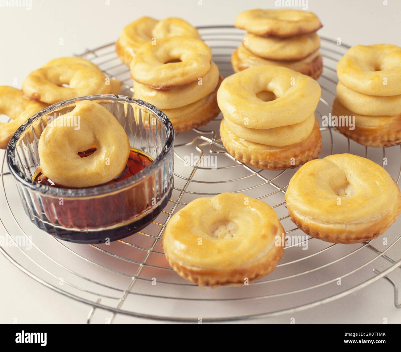 Dipping the choux crowns in the caramel Stock Photo - Alamy