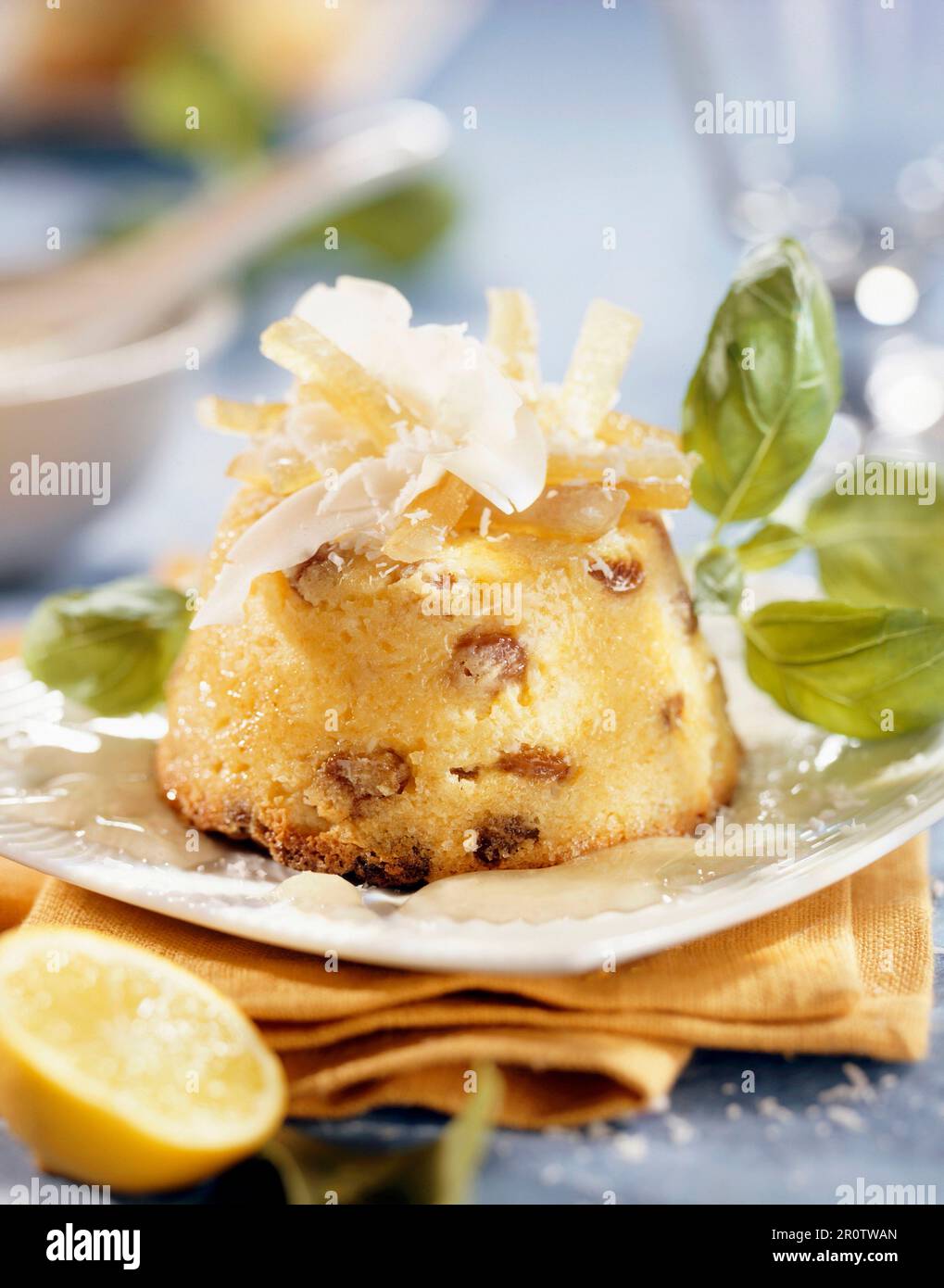 Moist sponge with coconut, lemon and basil sauce Stock Photo - Alamy