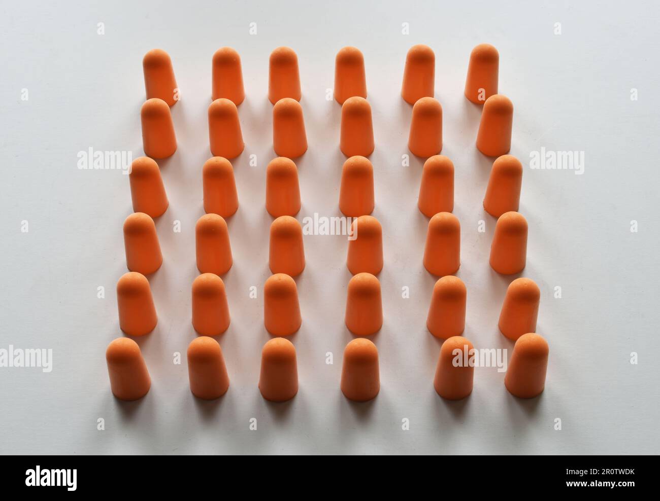 Orange foam ear plugs isolated on white background Stock Photo - Alamy