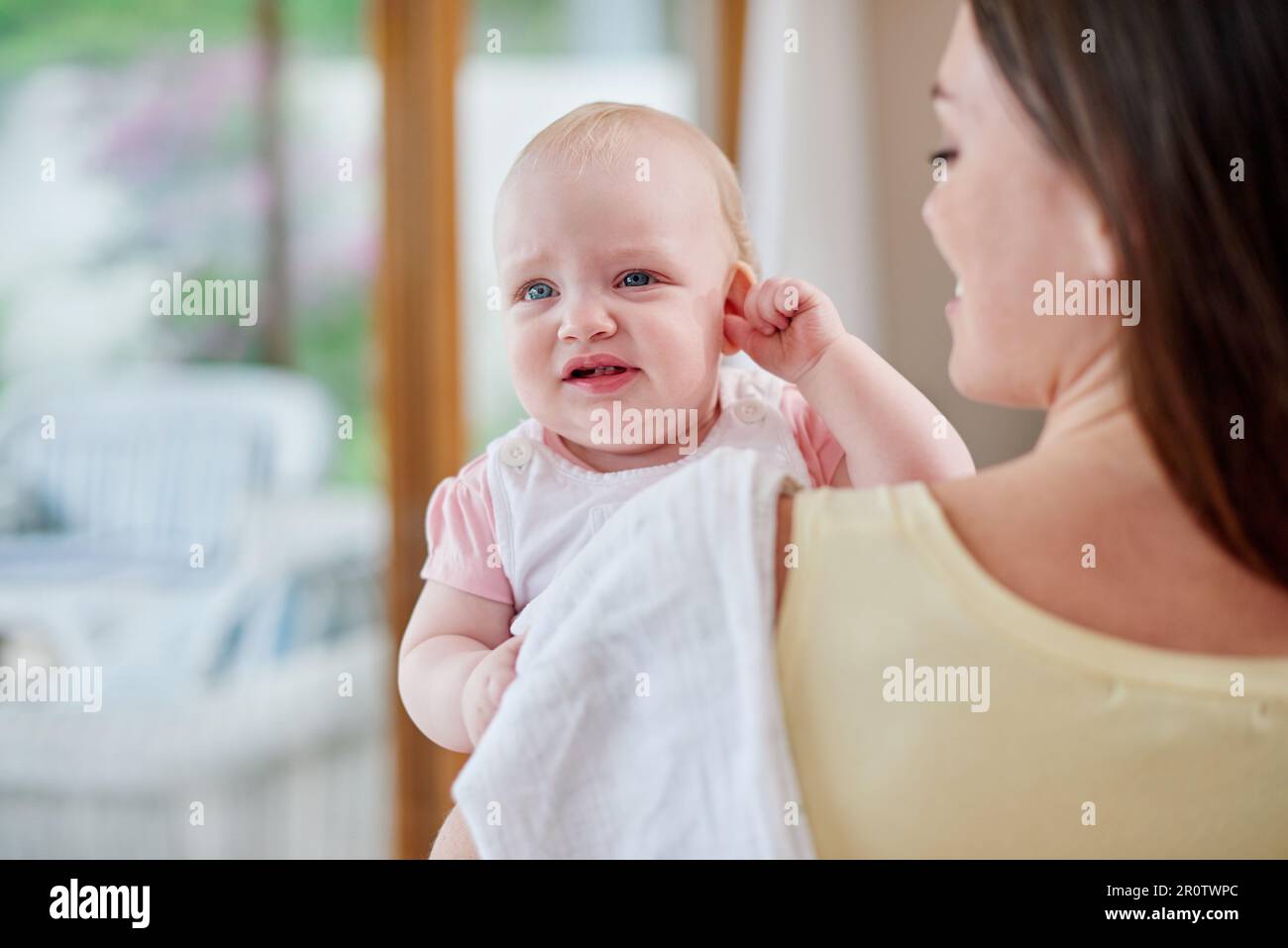 There there baby. Over the shoulder shot of a baby girl being consoled ...