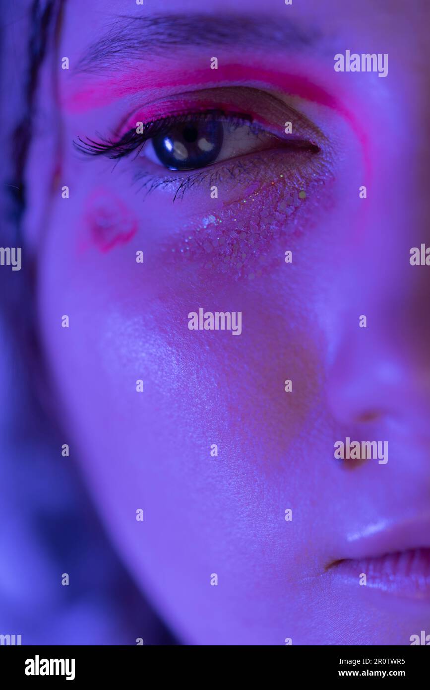 Half young female face with shiny stage make-up with sparkles and ...