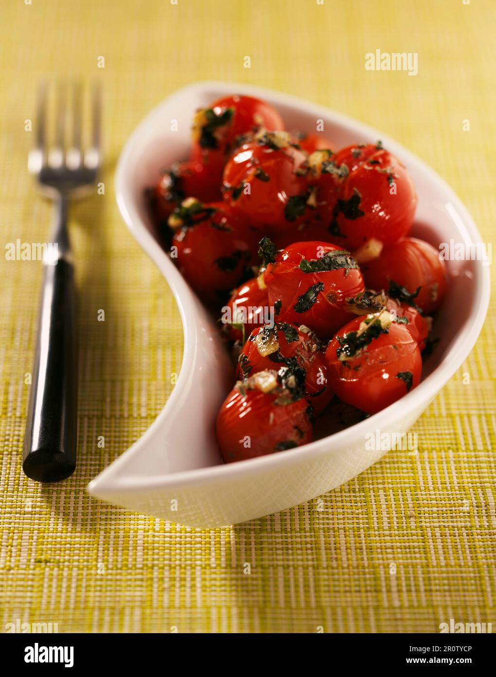 sauteed cherry tomatoes with basil Stock Photo - Alamy