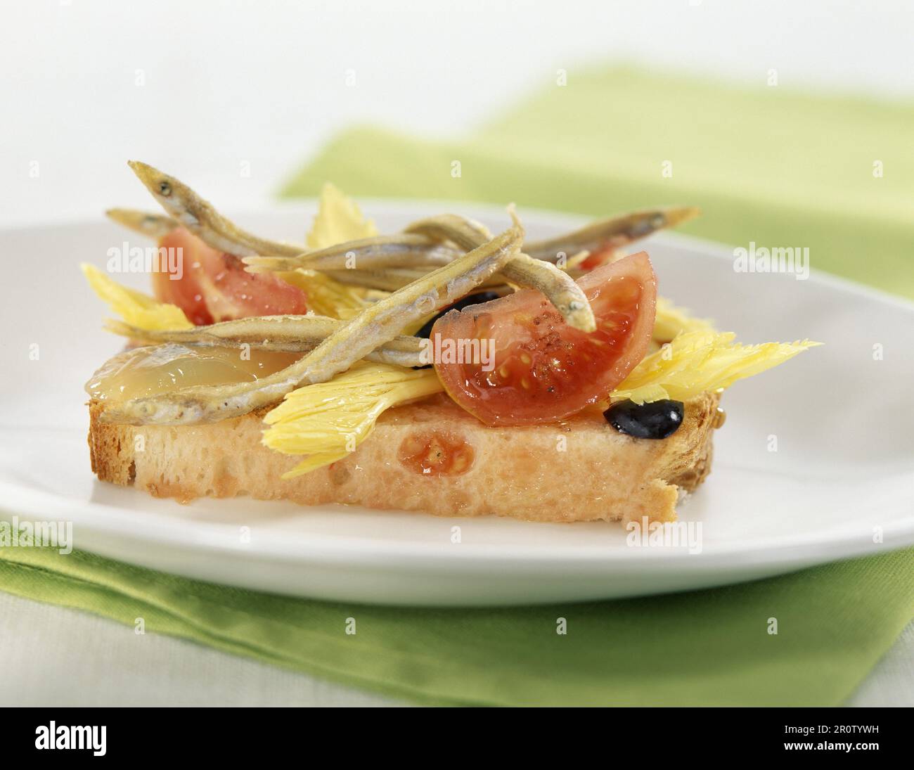 tomato bread with fried sand lance and celery salad Stock Photo - Alamy