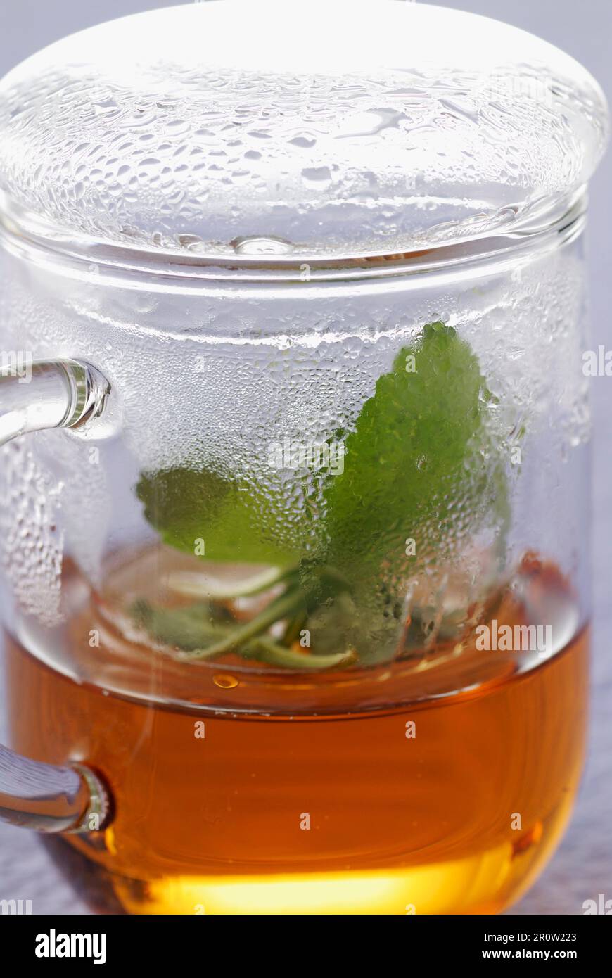 Glass cup of infusion Stock Photo - Alamy