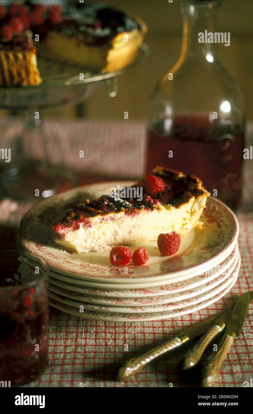 A slice of Alsatian raspberry cake on a stack of plates Stock Photo - Alamy