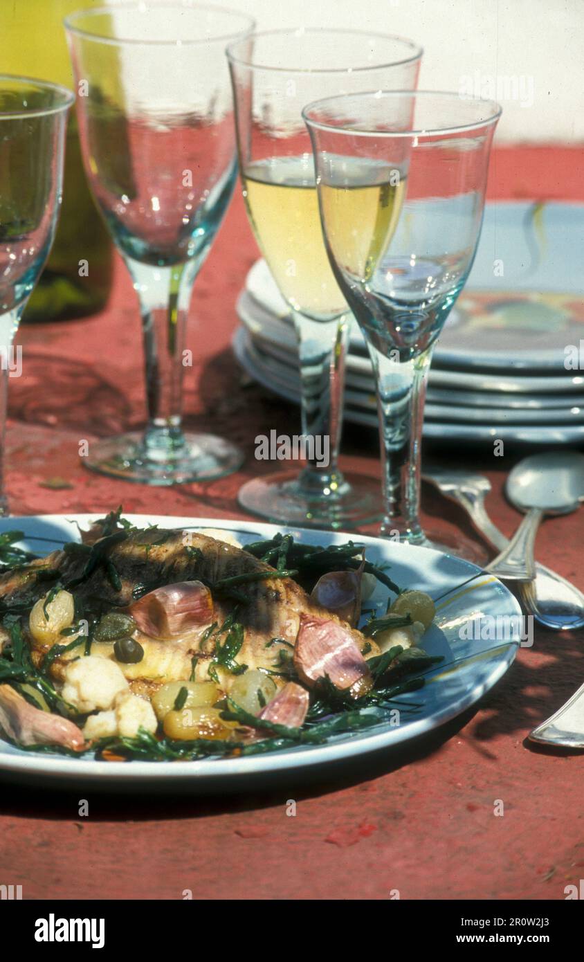 Ray fish with fried garlic and capers Stock Photo - Alamy