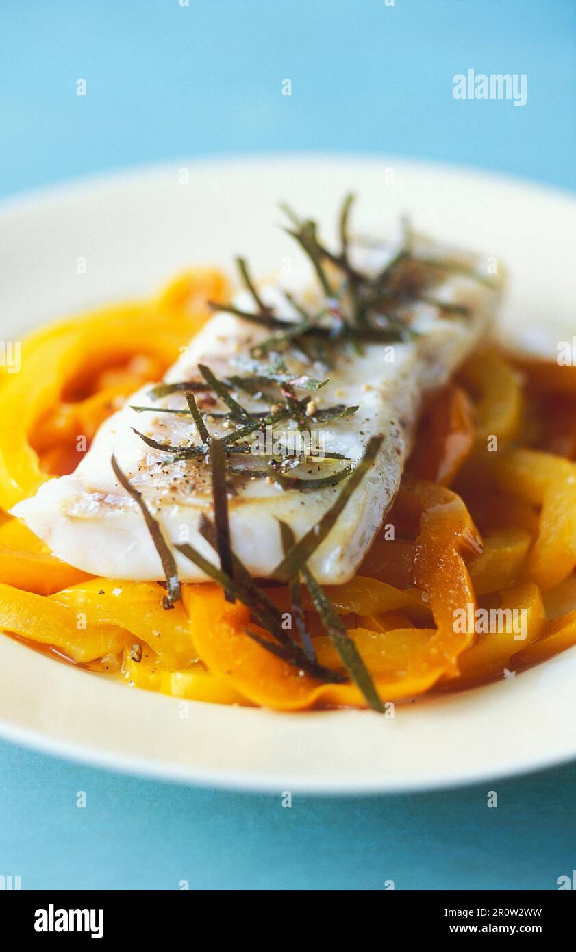 Cod fillet with bay leaves on a yellow pepper medley Stock Photo - Alamy