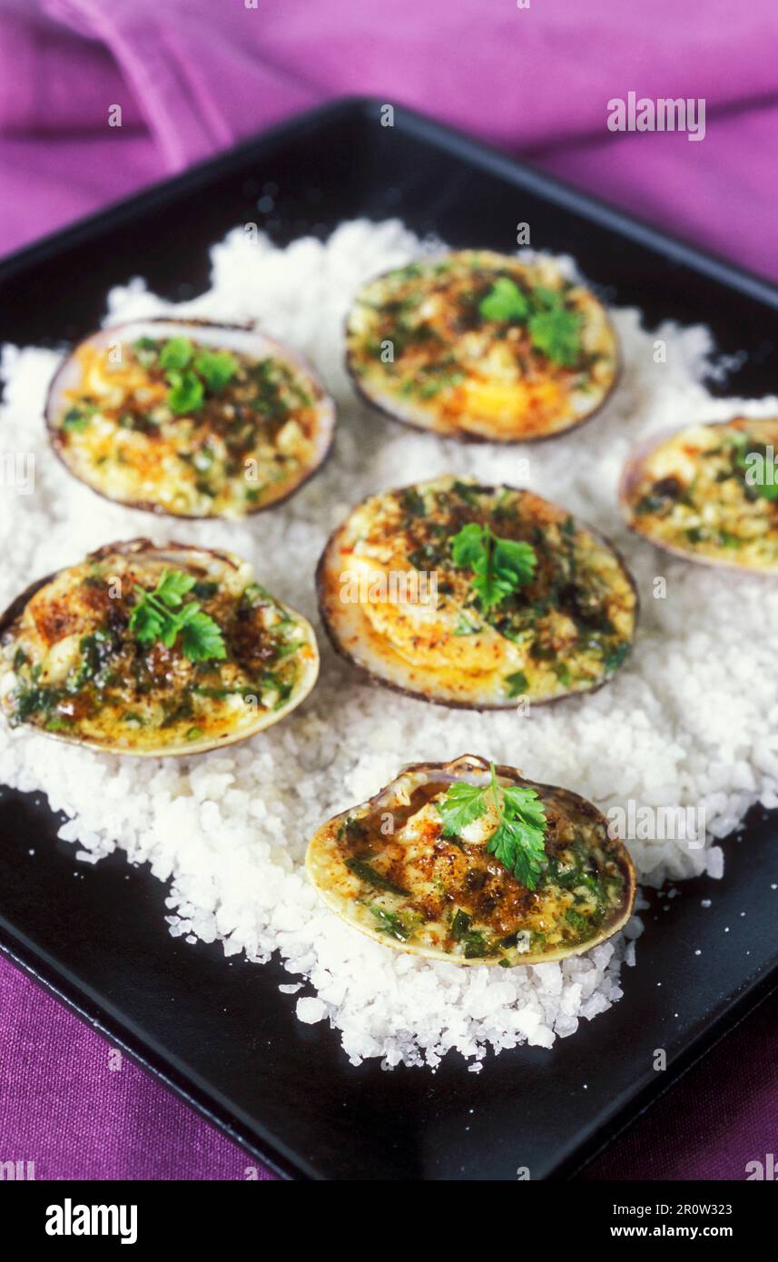 Gratinated mussels with algae powder, chilli and herb butter Stock ...
