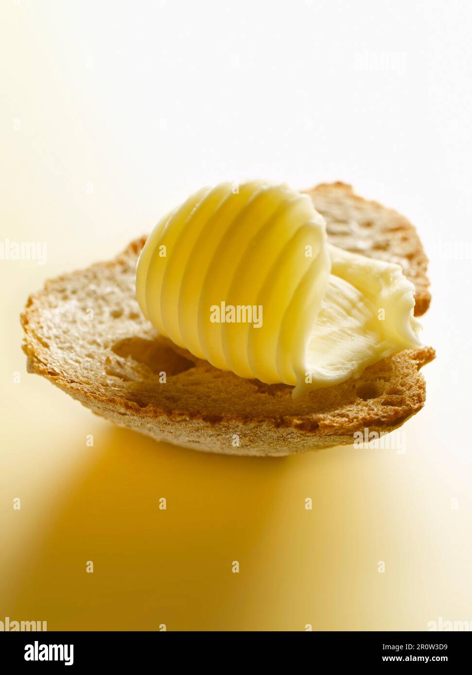 Butter on a piece of bread Stock Photo - Alamy