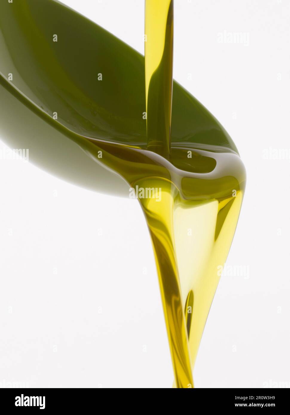 Pouring olive oil into a spoon Stock Photo - Alamy