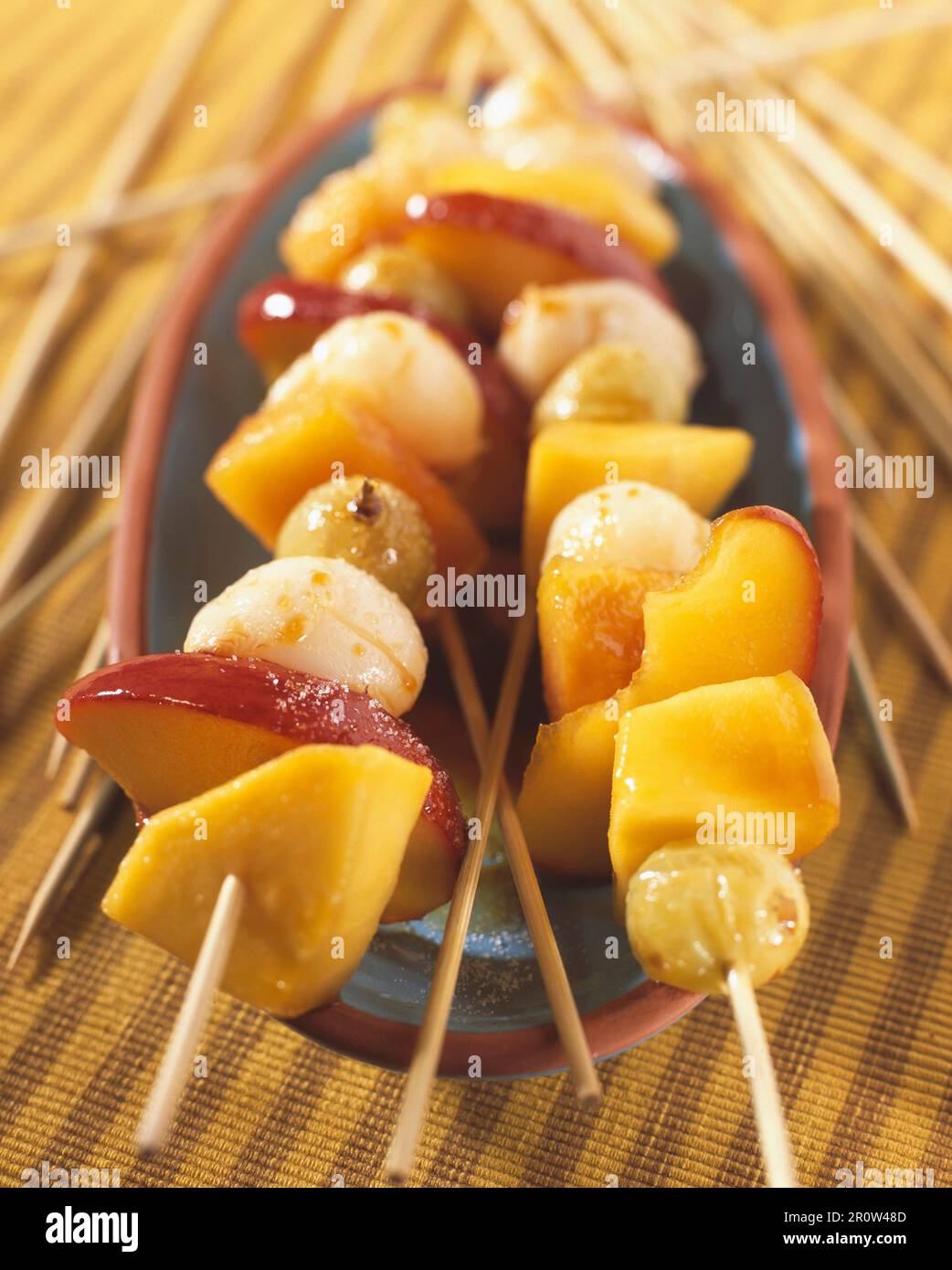 Lychee and caramelized fruit brochettes Stock Photo - Alamy