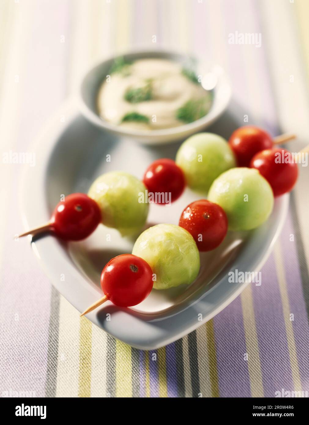 Cucumber balls and cherry tomato brochettes with dip Stock Photo - Alamy