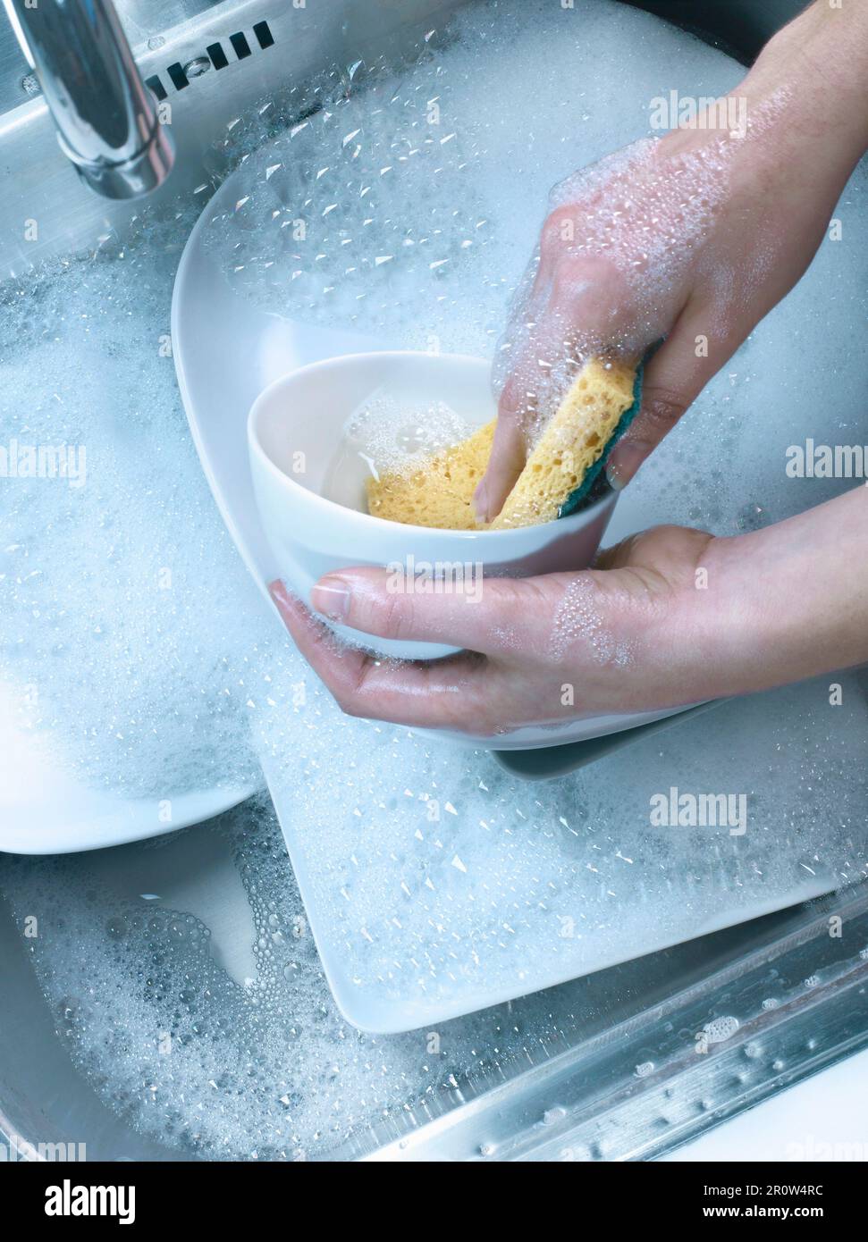 Washing the dishes in the sink Stock Photo - Alamy