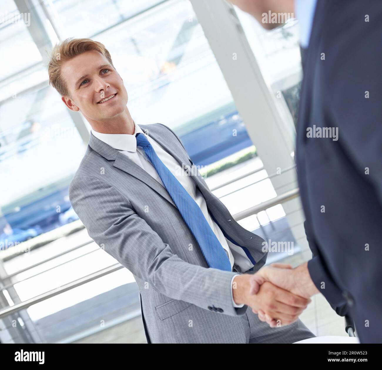 Congratulations on your recent promotion. Two businessmen shaking hands ...
